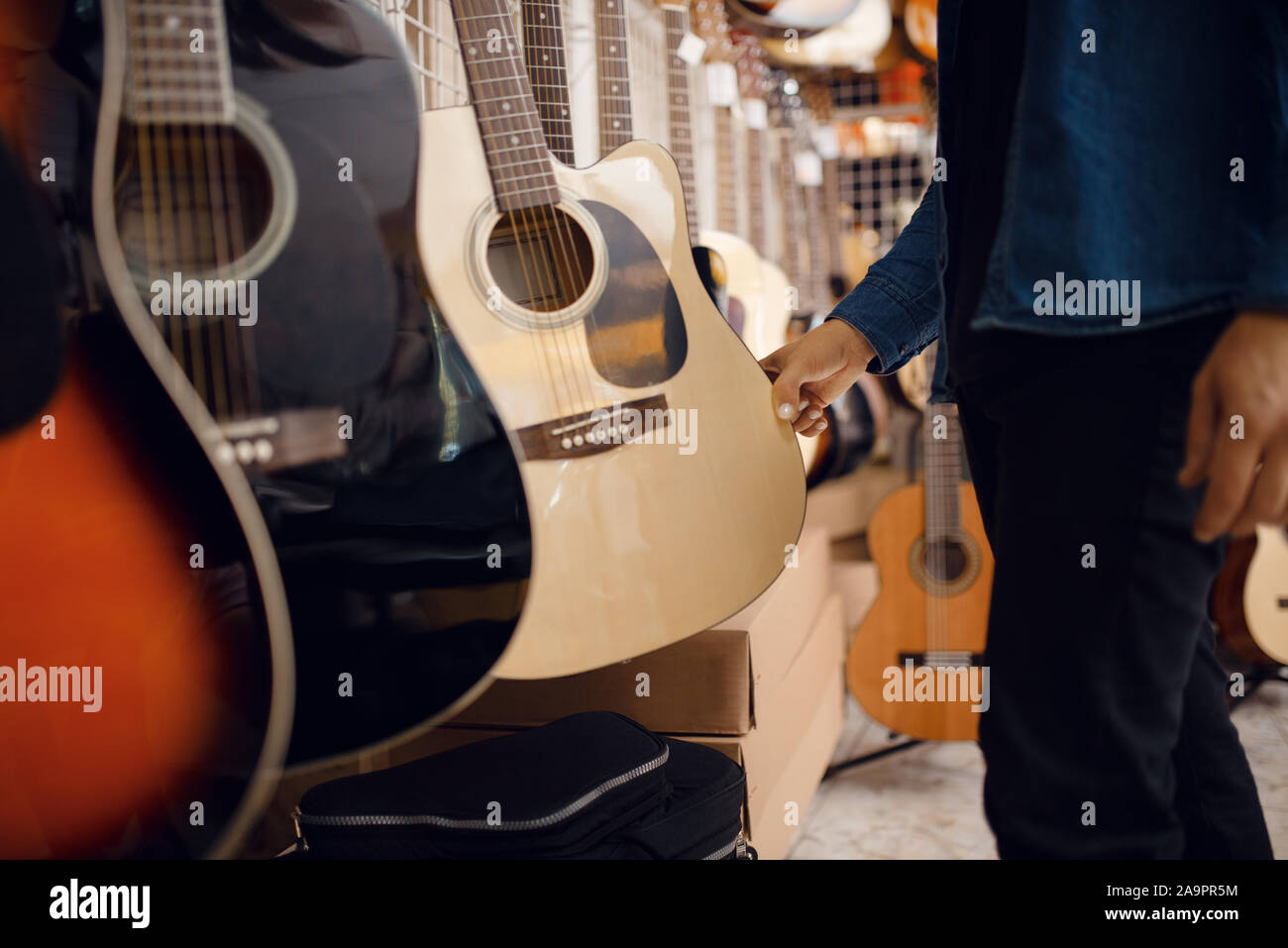 Customer trying guitar hi-res stock photography and images - Alamy
