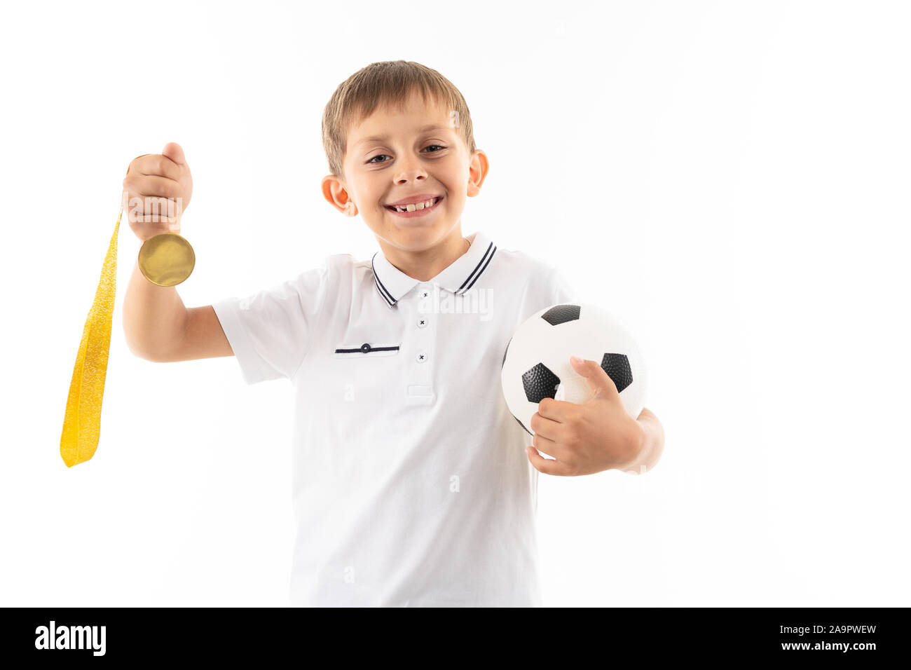 A little blonde boy win and holds soccer ball and a gold medal, picture ...