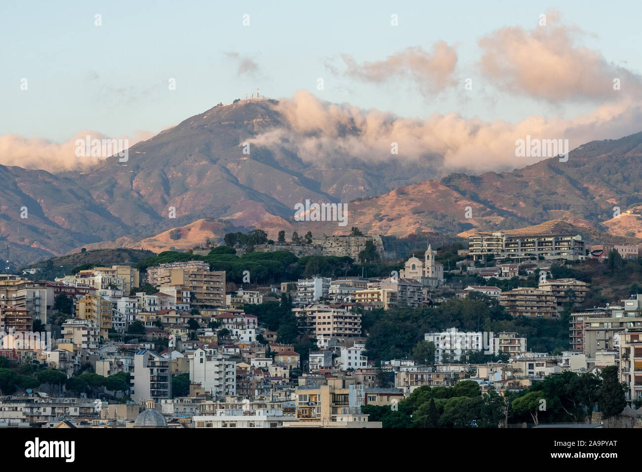 sunrise at messina harbor with view on the city center and mountains in ...