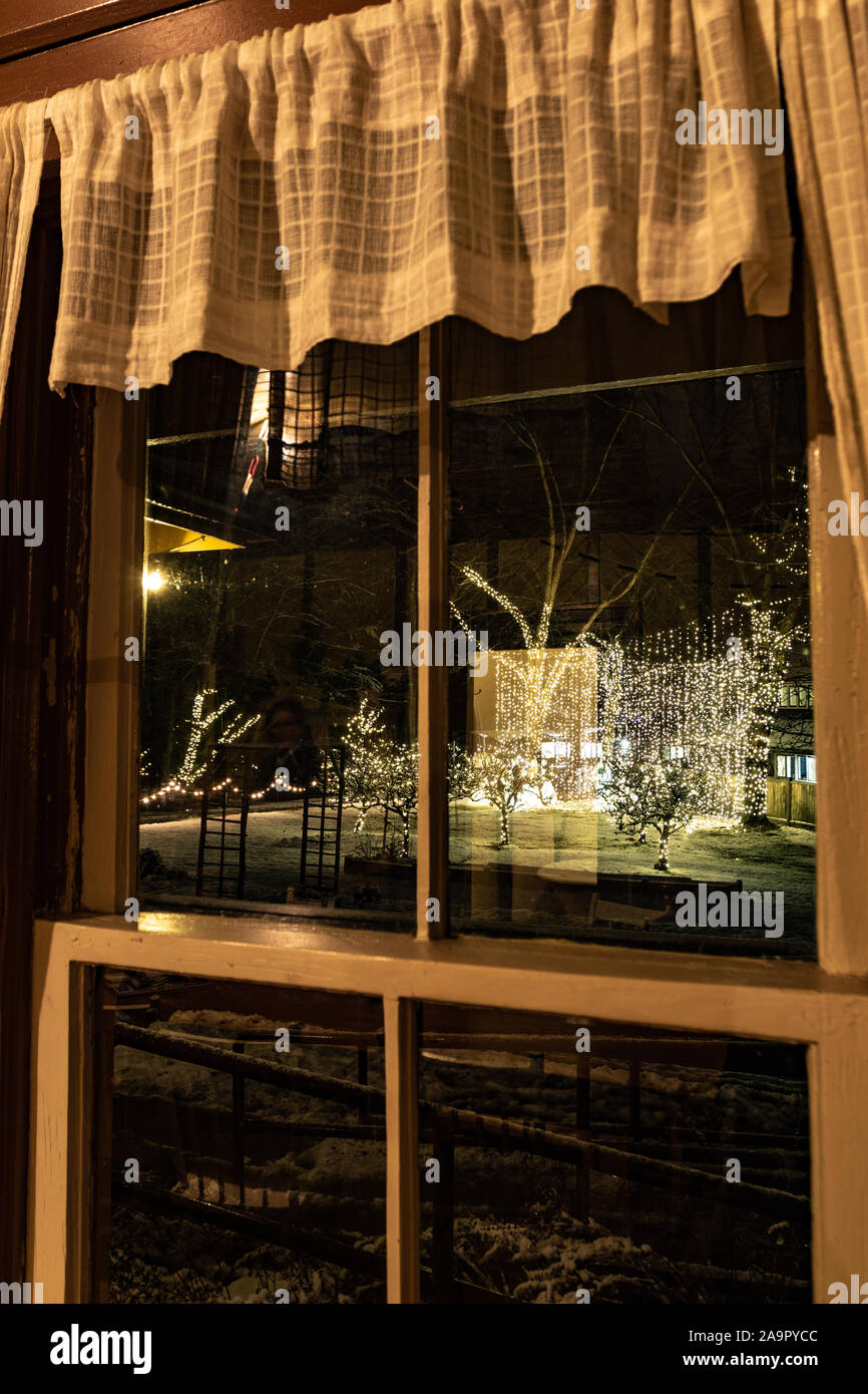 Outdoor string christmas lights visible from window while inside Stock ...