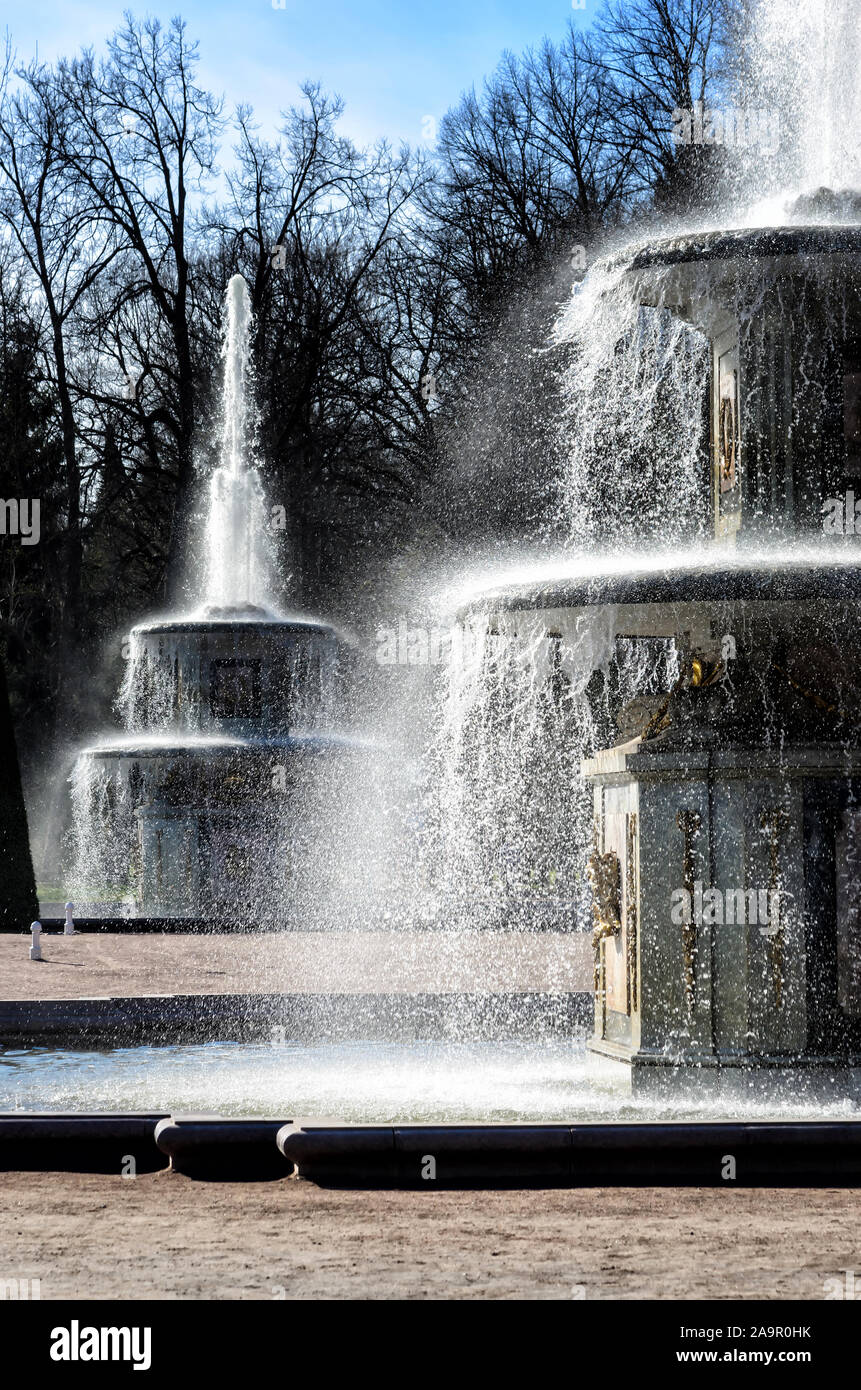 Fountain with shining light in spring with branches Stock Photo - Alamy