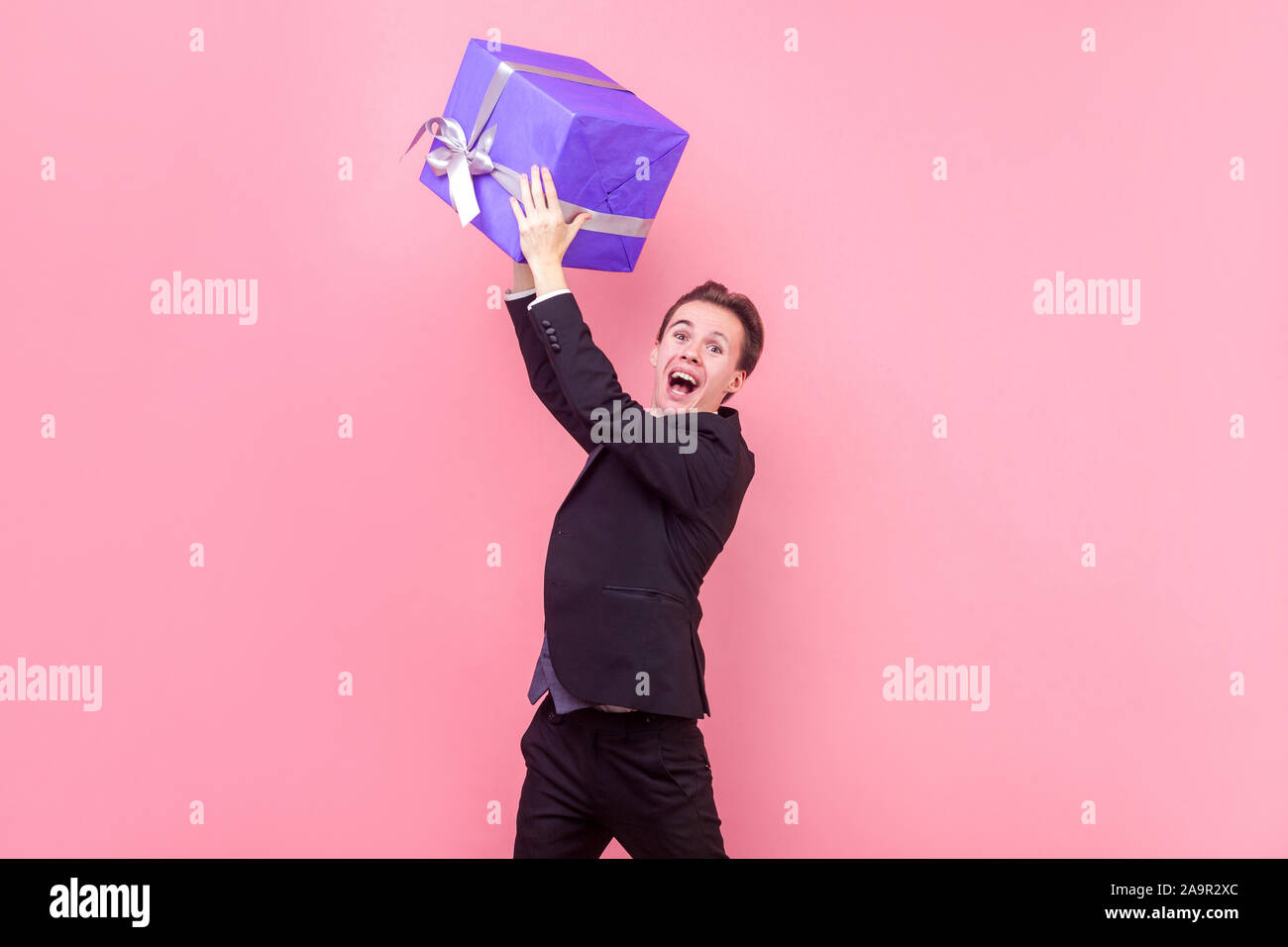 Portrait of overwhelmed happy man in suit and with stylish haircut ...