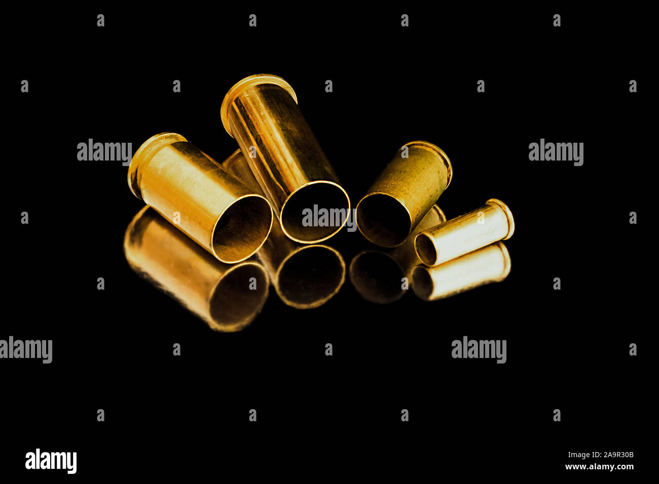 Comparison of sizes of different used bullet shells on a black isolated ...