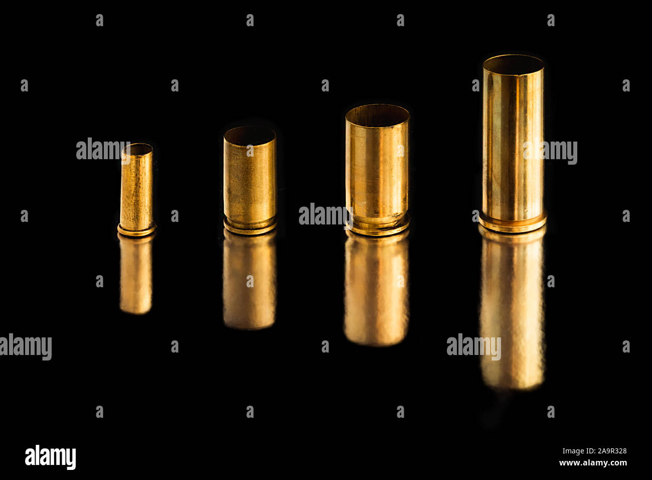 Comparison of sizes of different used bullet shells on a black isolated ...