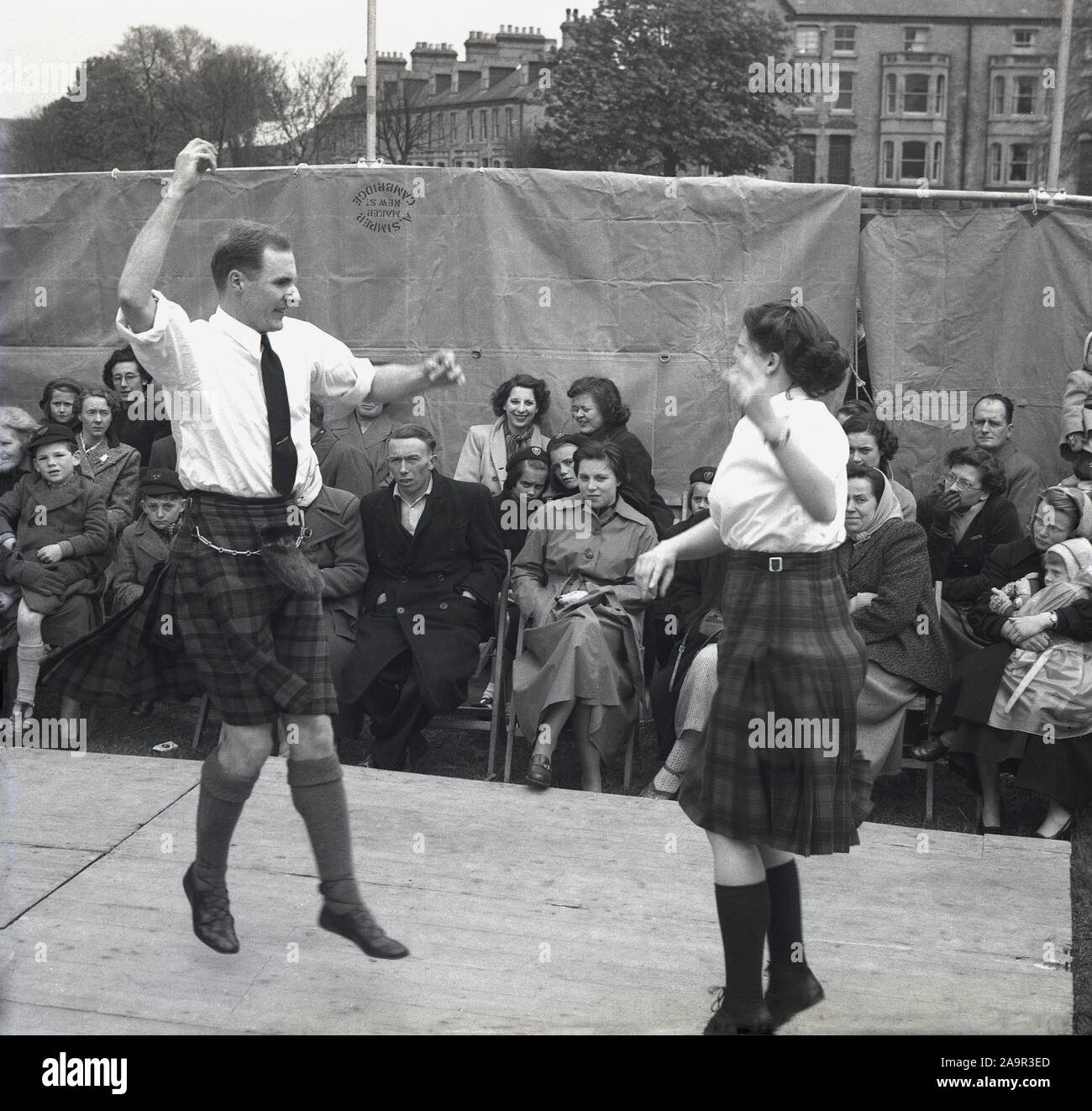 1950s, historical, a man and womann in kilts doing scottish country ...