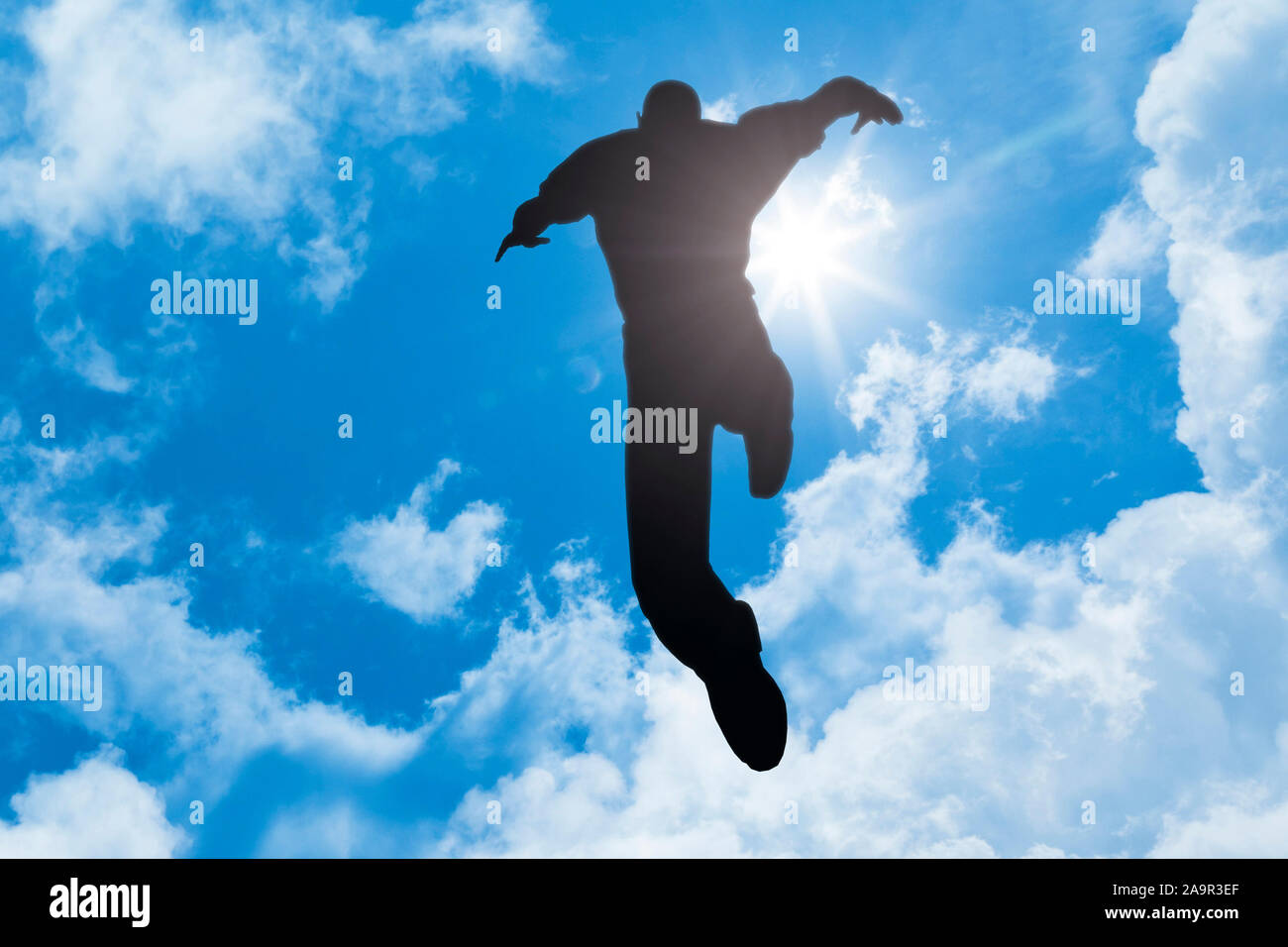 An image of a jumping man in the blue sky Stock Photo - Alamy