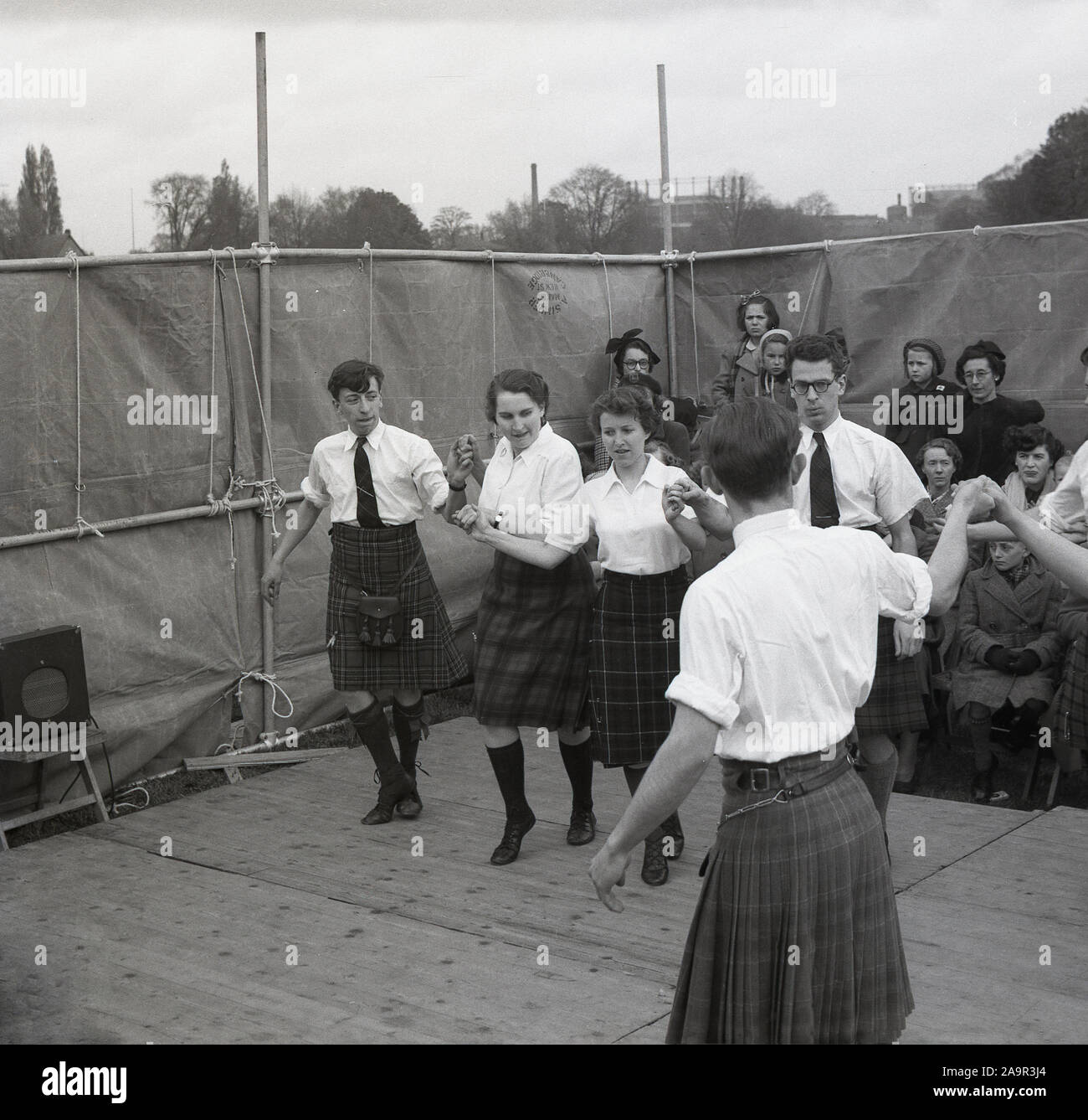 1950s, historical, men and women in kilts doing scottish country ...