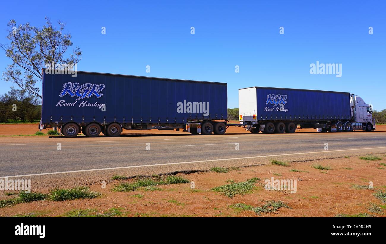 MEADOW, AUSTRALIA -7 JUL 2019- View of a road train with a long road ...