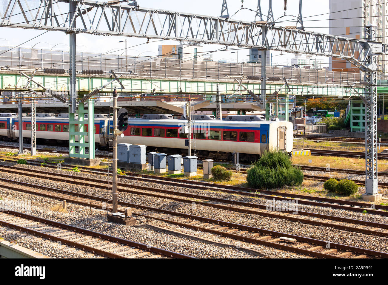 Railroad infrastructure and train passing by. Railway power supply ...