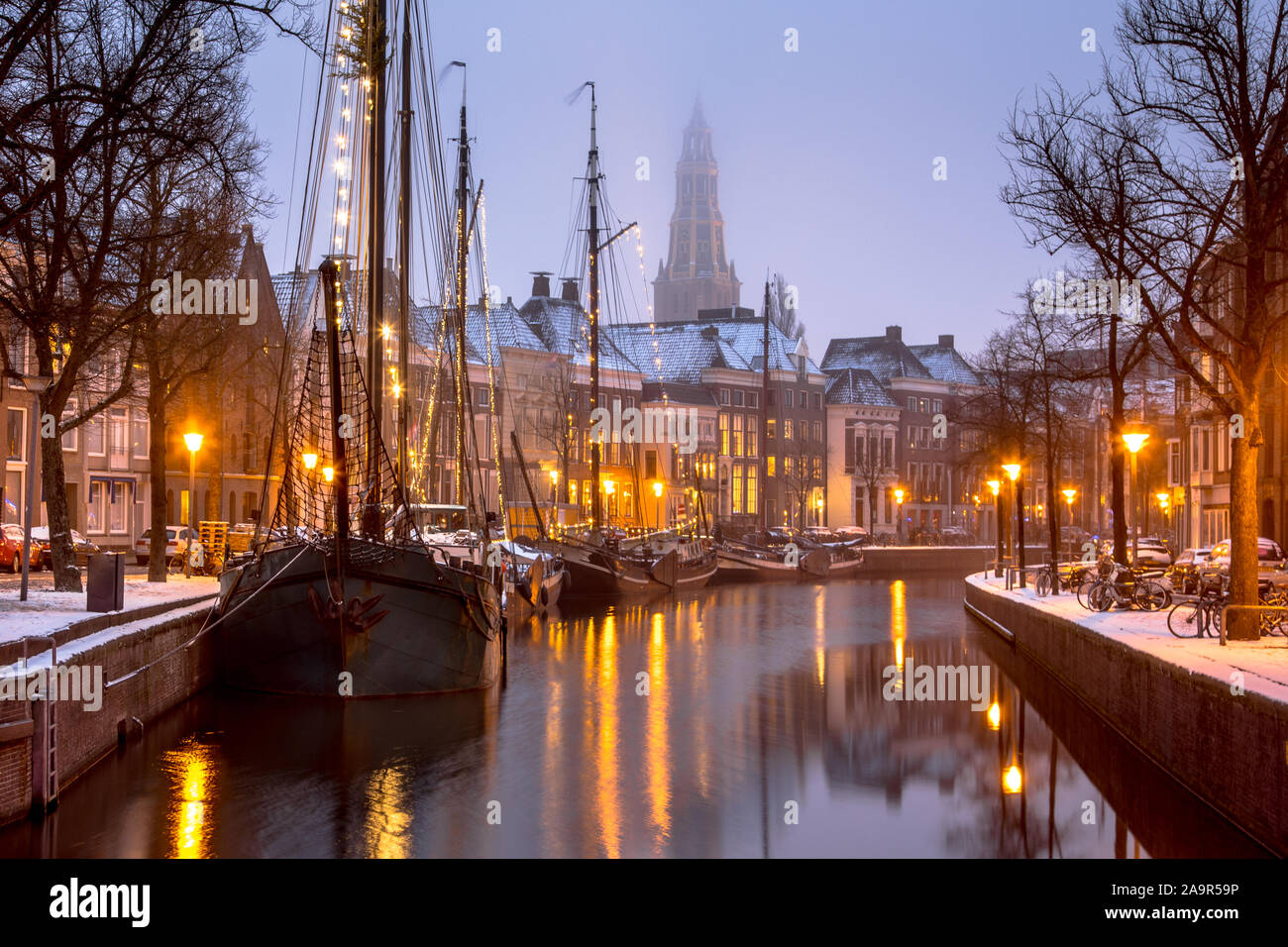 Historic sailing ships covered in snow at Hoge der Aa quay on ...