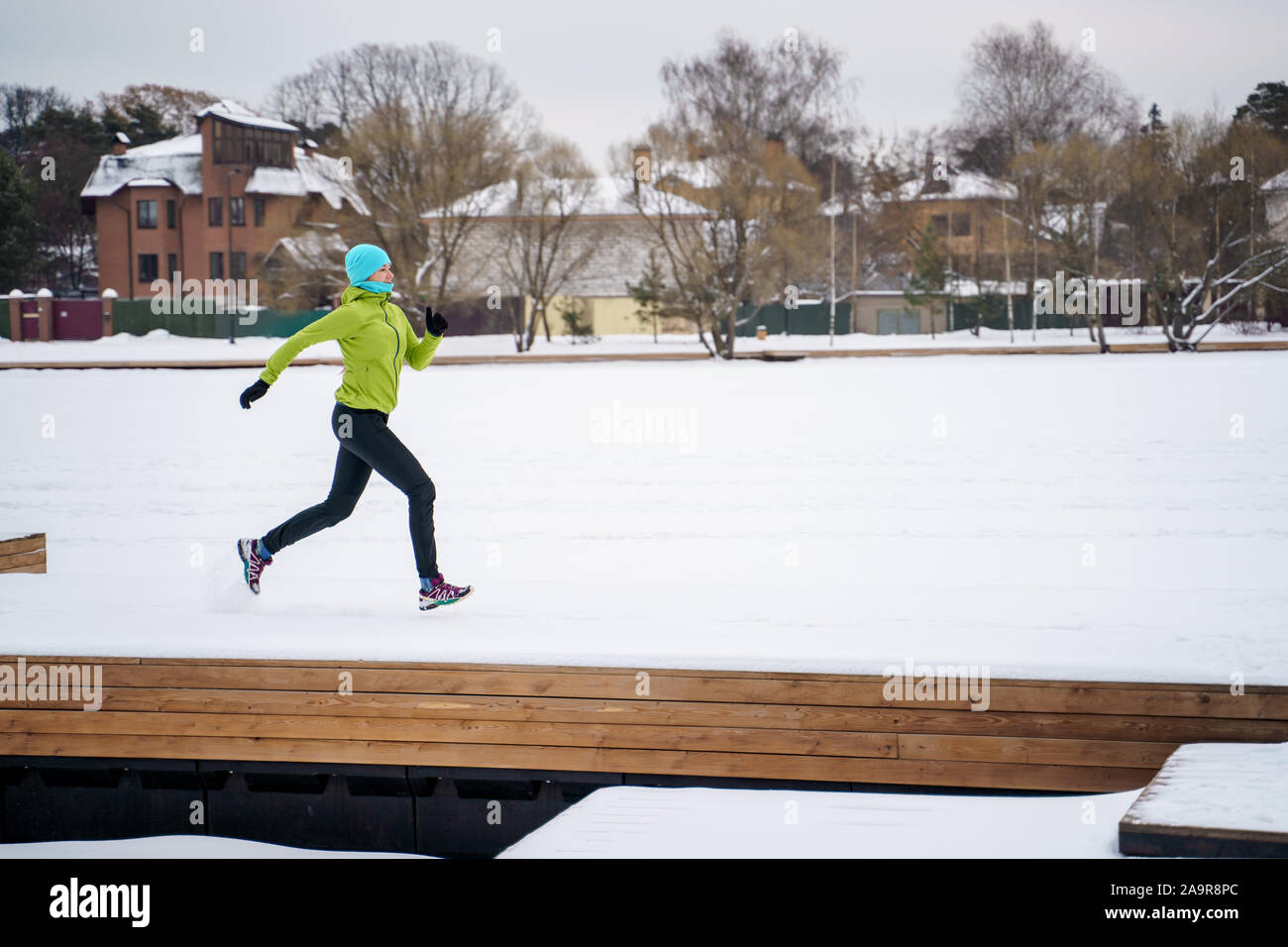 Picture of young athlete running in winter park in afternoon Stock ...