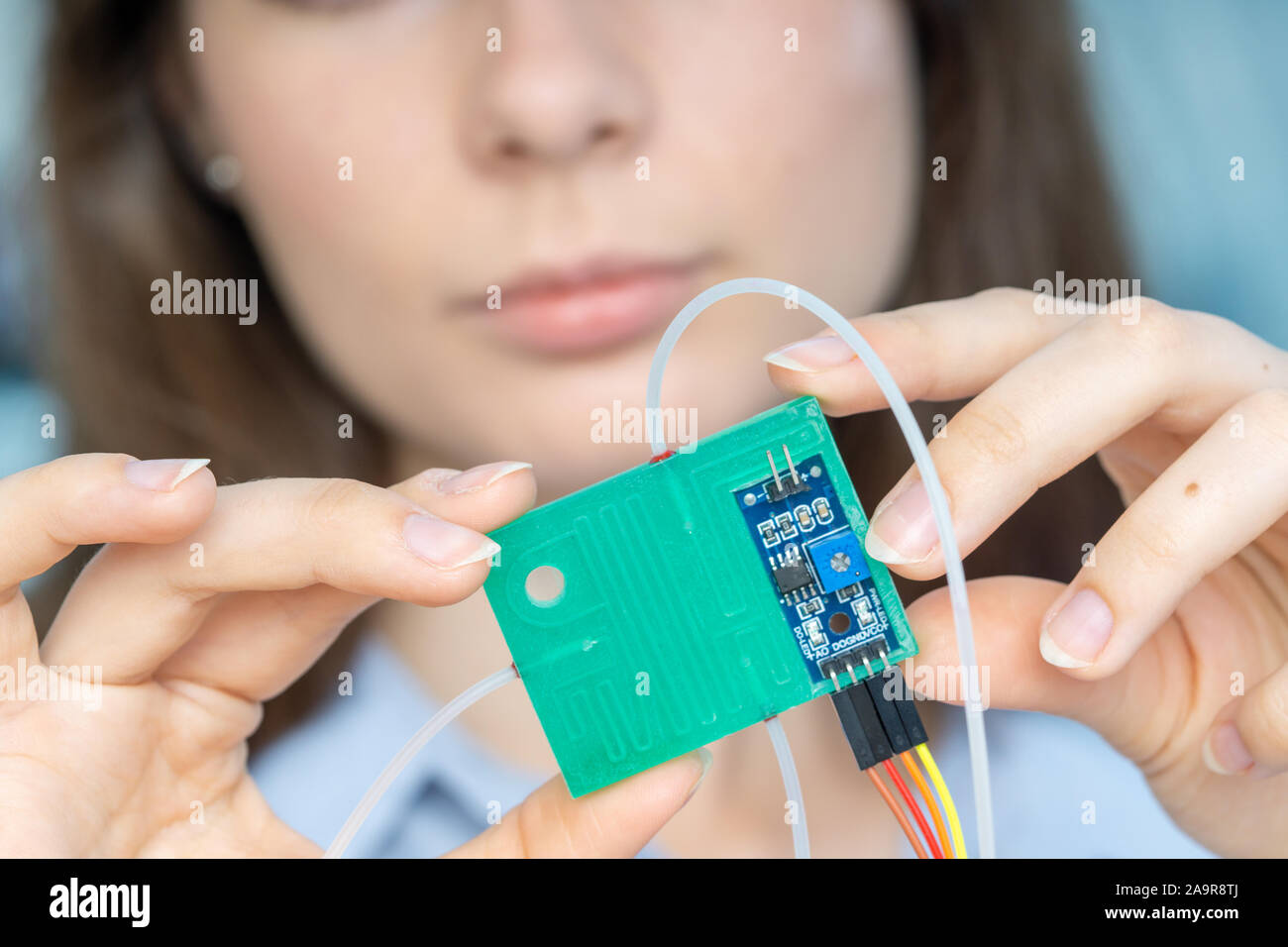 Young scientist woman in microbiological lab with lab-on-chip LOC ...
