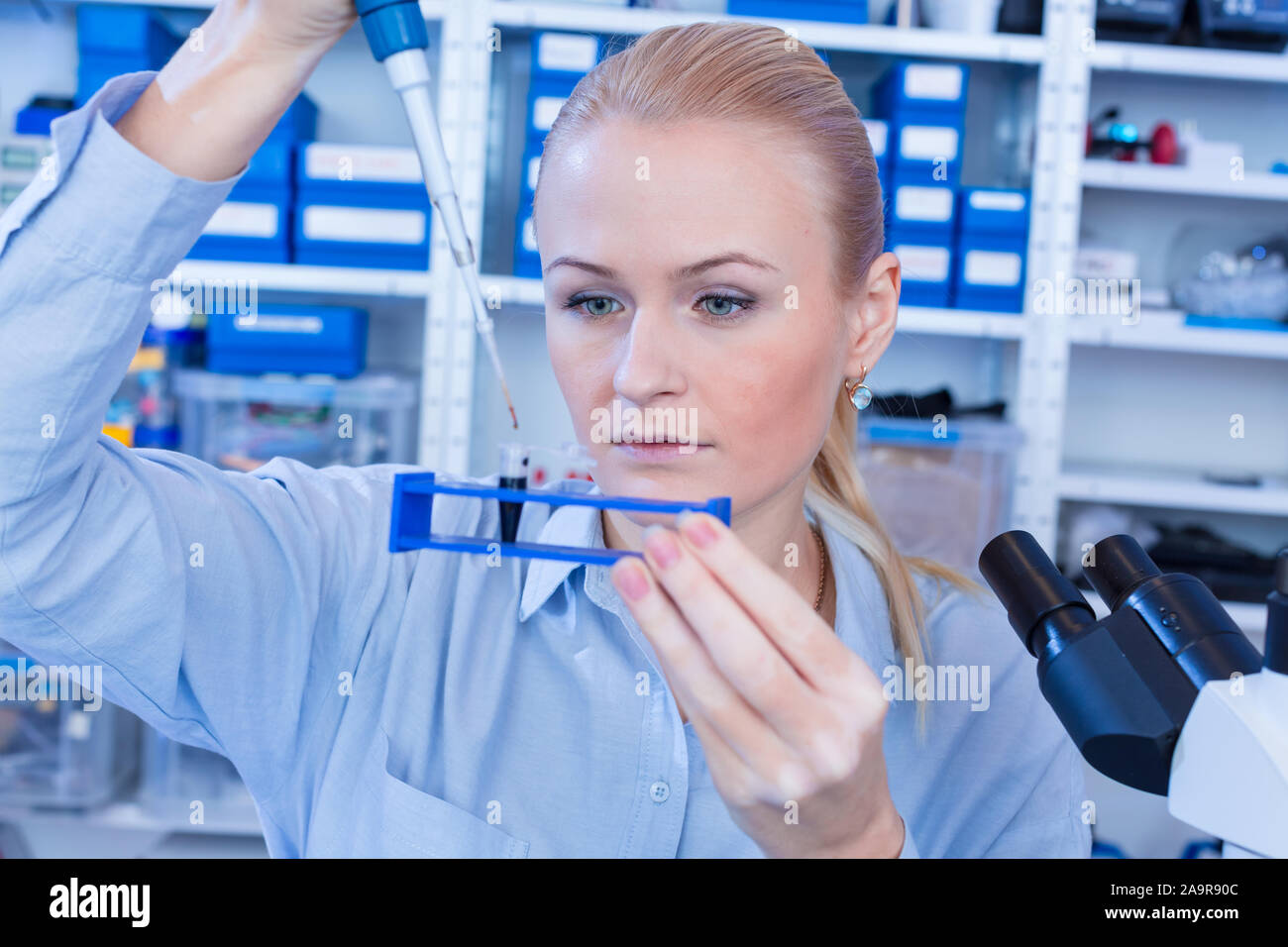 Female technician in laboratory of genetics - reprogenetics. Young ...