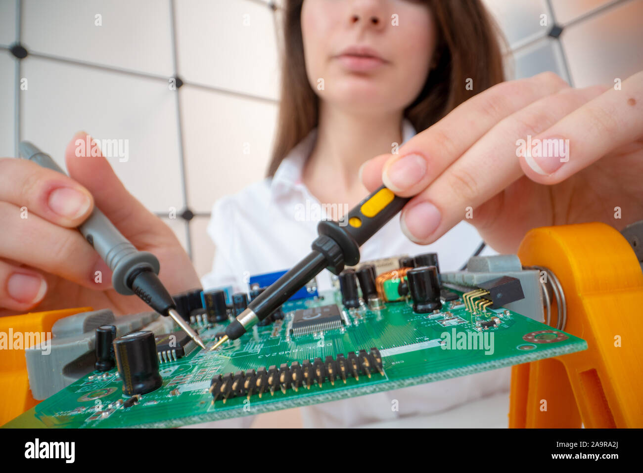 Young woman with measuring devices in the electronics engineer ...