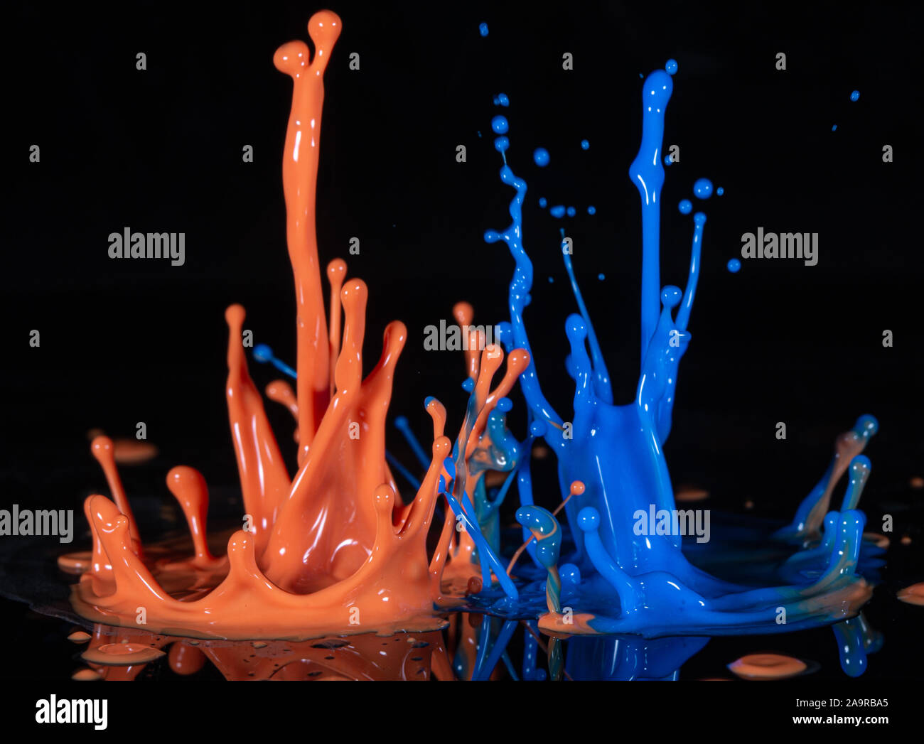 Color ink splash on a black background Stock Photo - Alamy