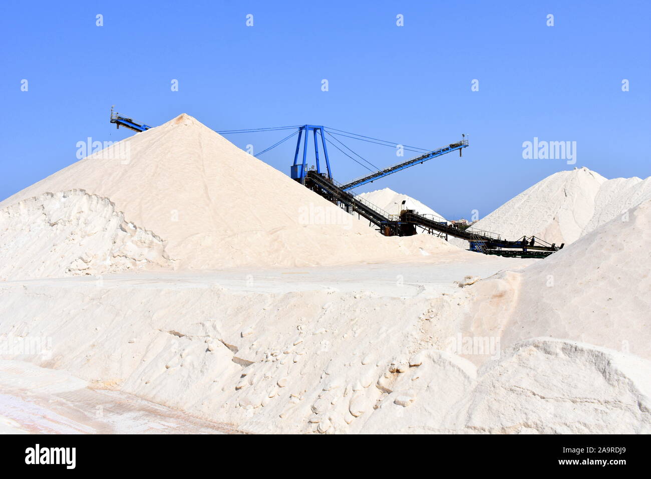 Salt mountains and machinery at the Torrevieja salt works, Torrevieja ...