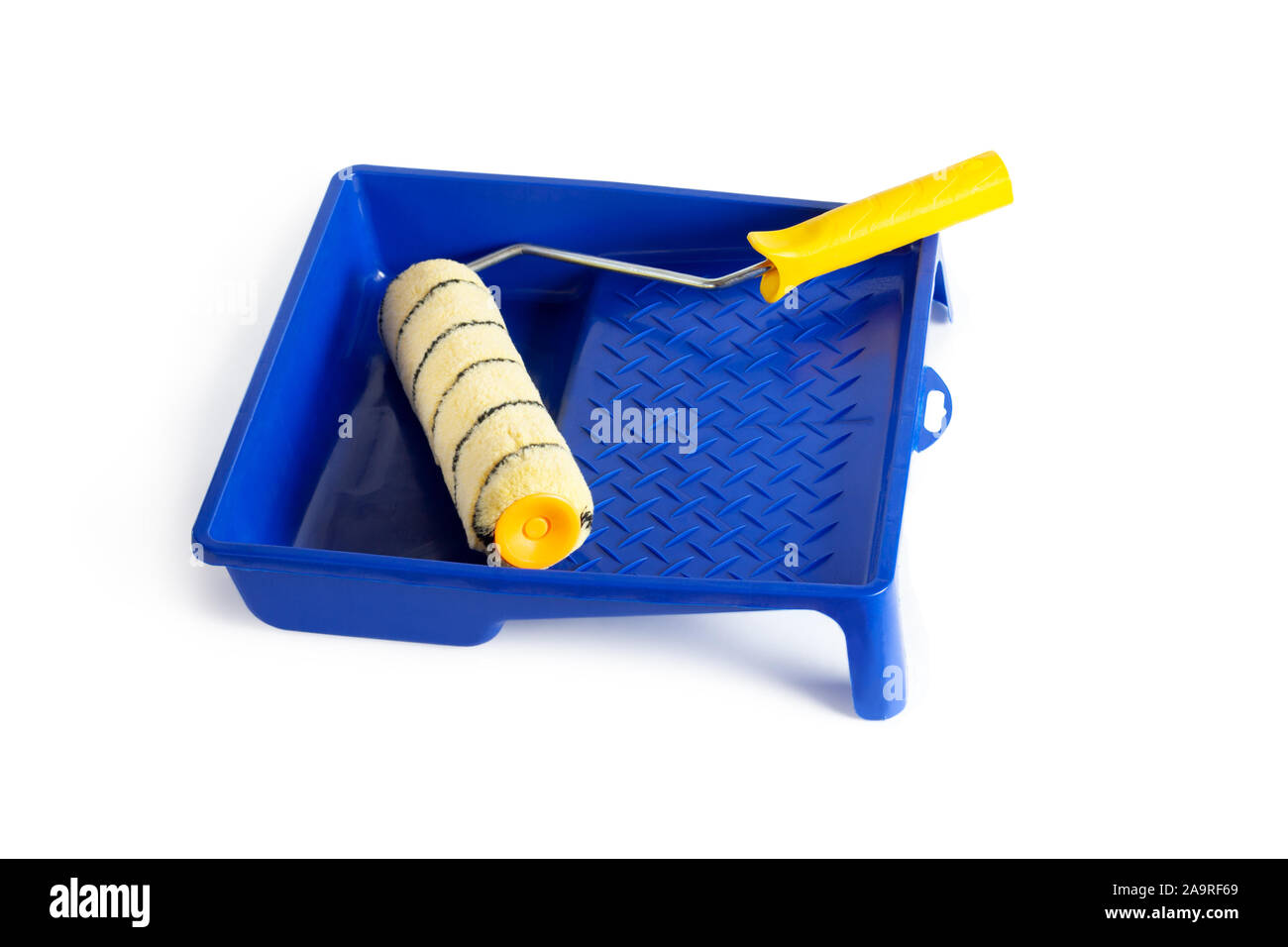 Paint roller with a yellow handle in a blue cuvette. Isolated over ...