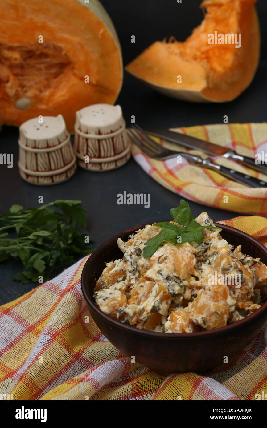 Pumpkin stewed in sour cream in a bowl on a dark background, Healthy ...
