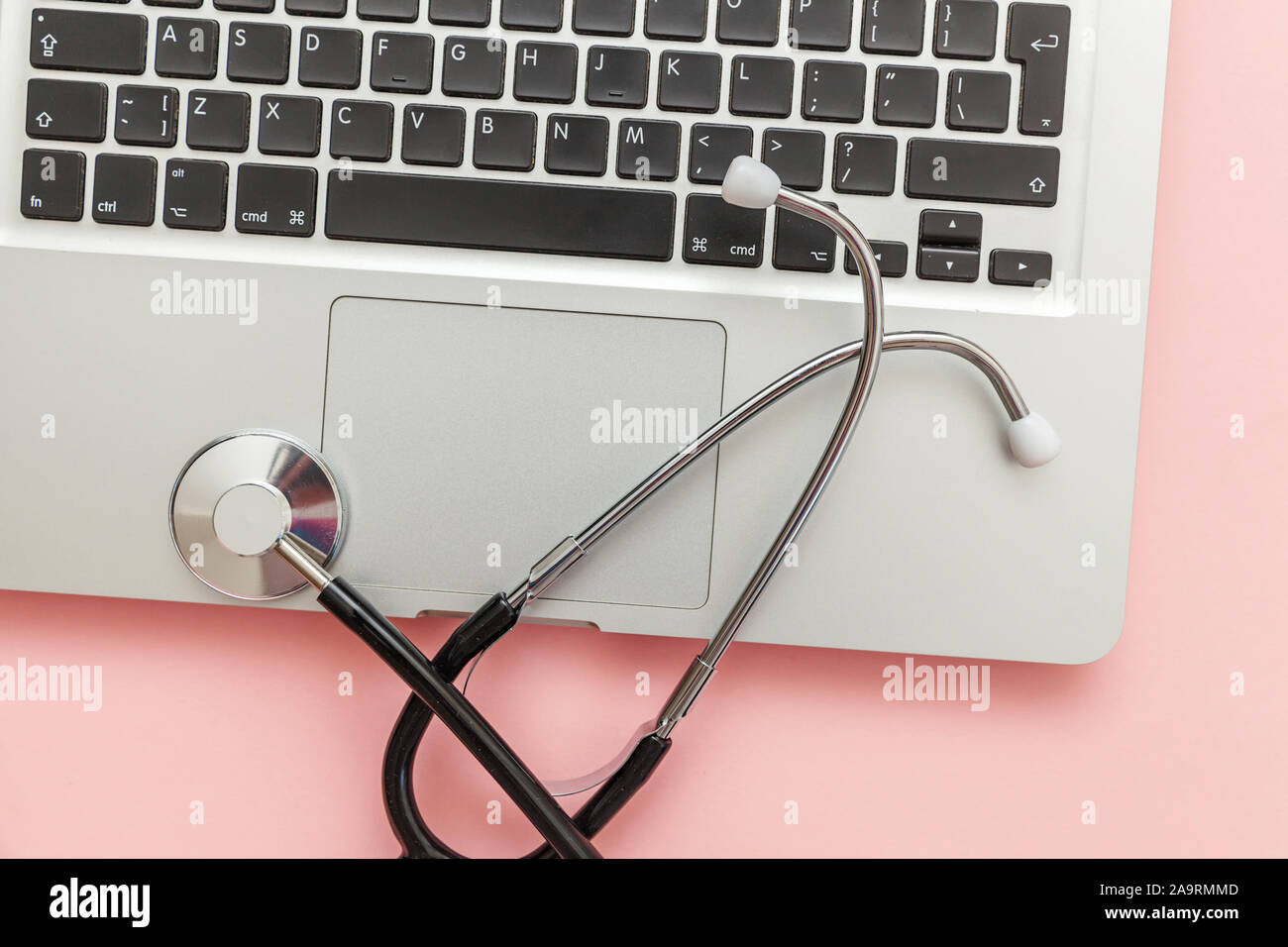 Stethoscope keyboard laptop computer isolated on pink background ...