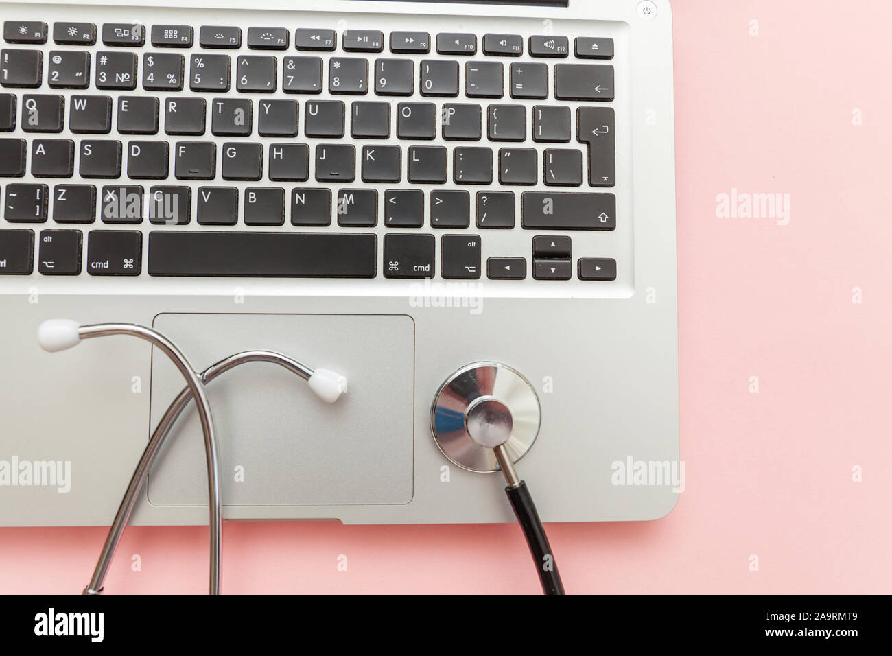 Stethoscope keyboard laptop computer isolated on pink background ...