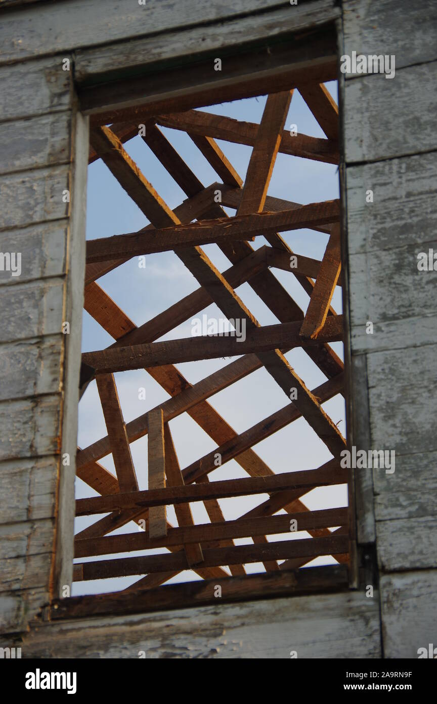 View through window to roof of wooden house being dismantled Stock ...