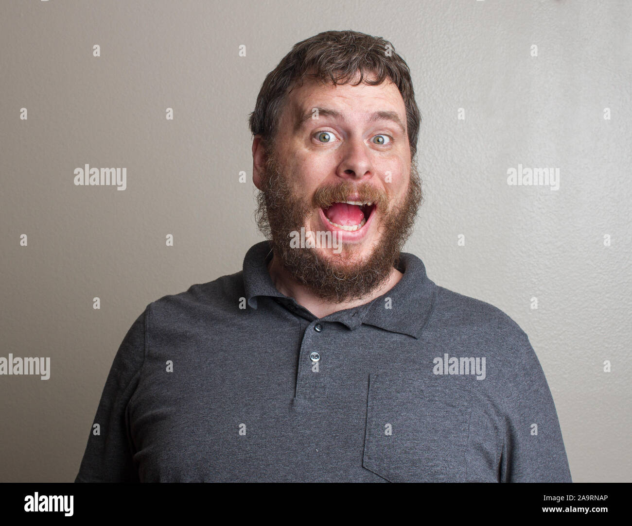 Make making a huge smile with his face Stock Photo - Alamy