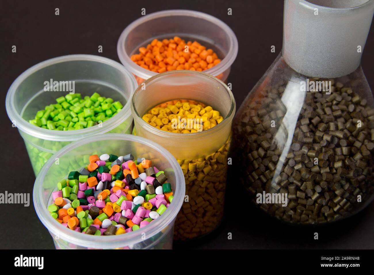 Plastic granules in a measuring container and test tubes in the ...