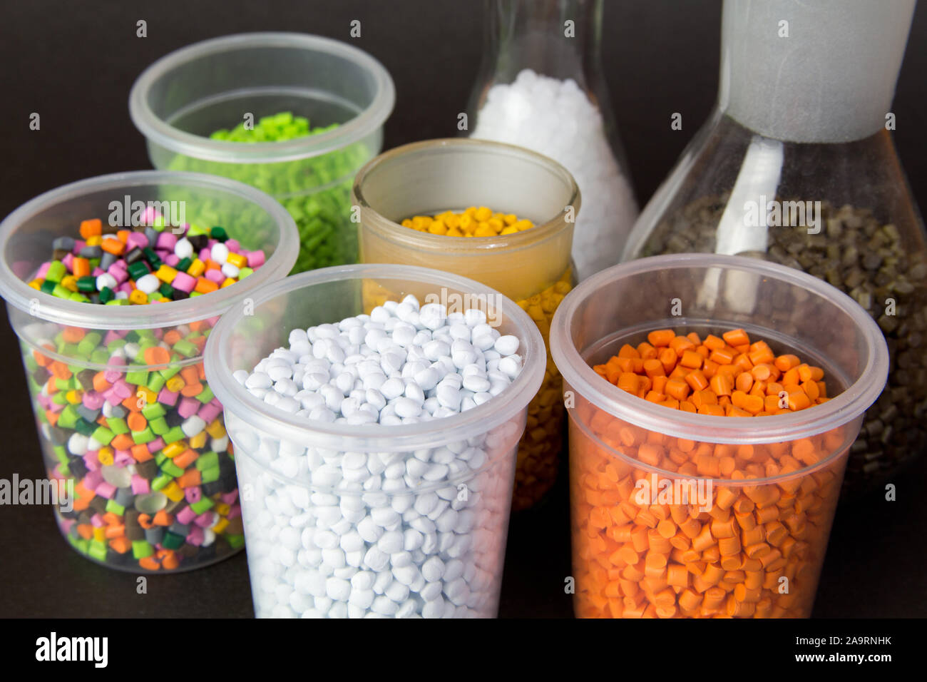 Plastic granules in a measuring container and test tubes in the ...