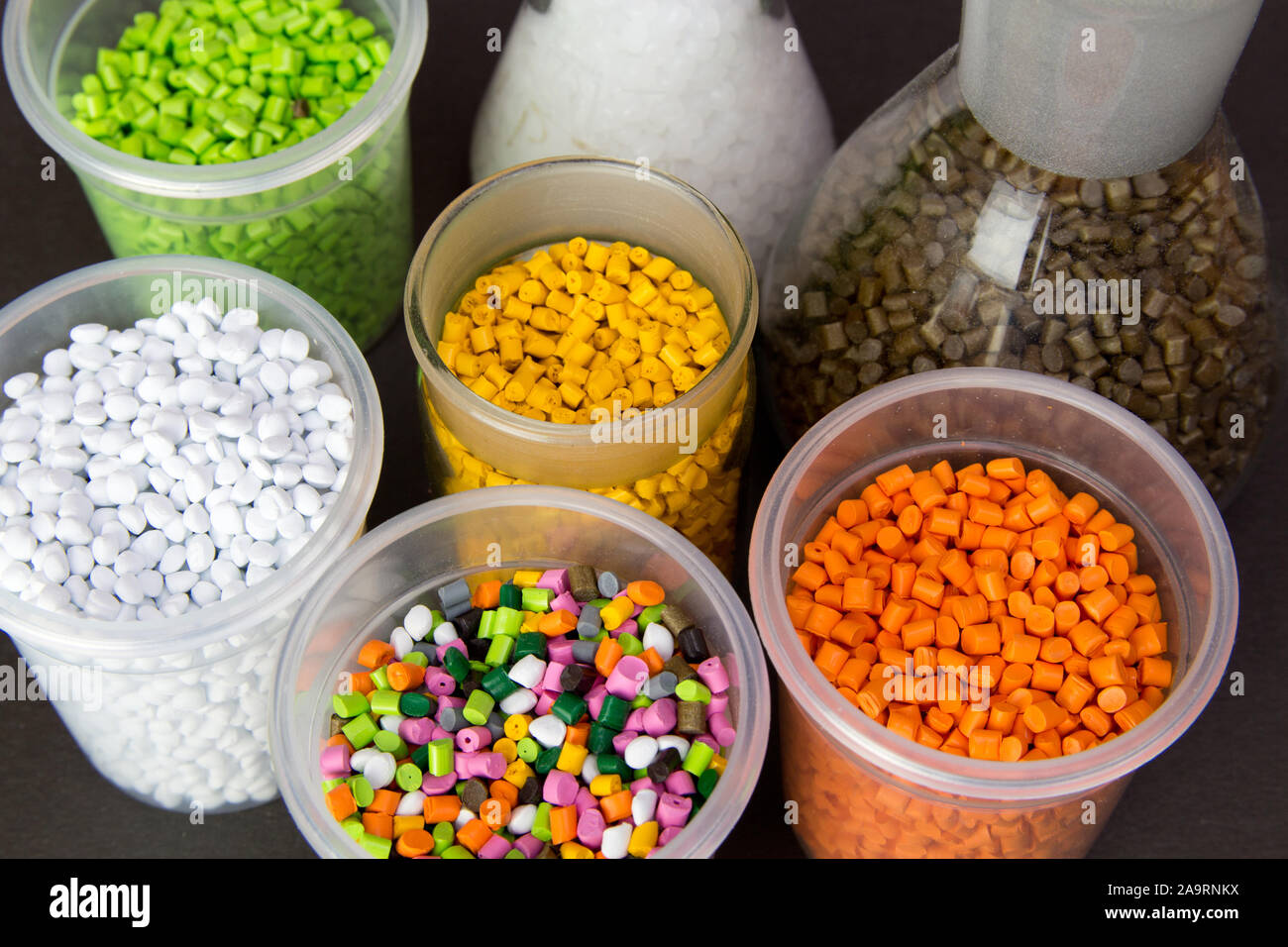 Plastic granules in a measuring container and test tubes in the ...