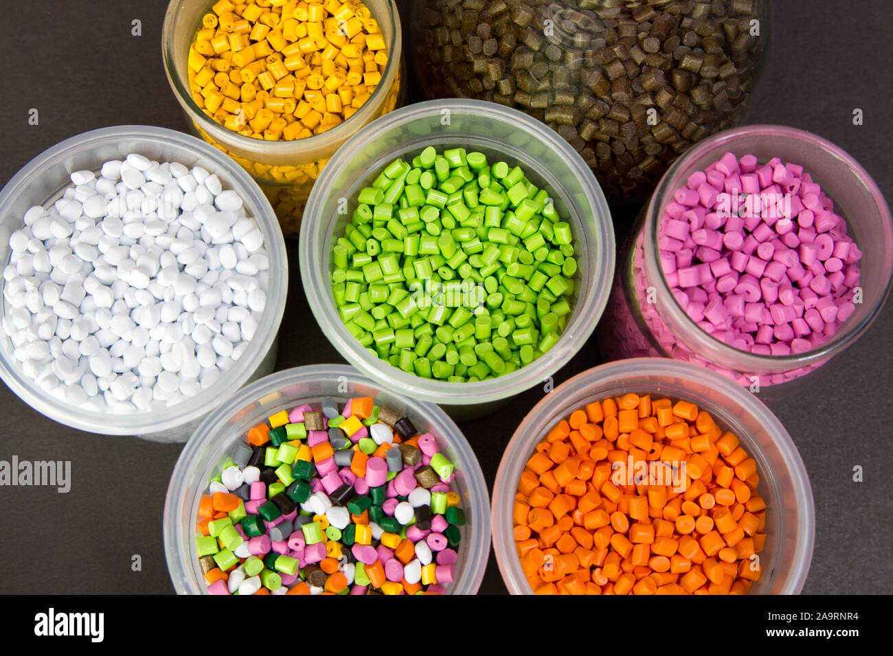 Plastic granules in a measuring container and test tubes in the ...