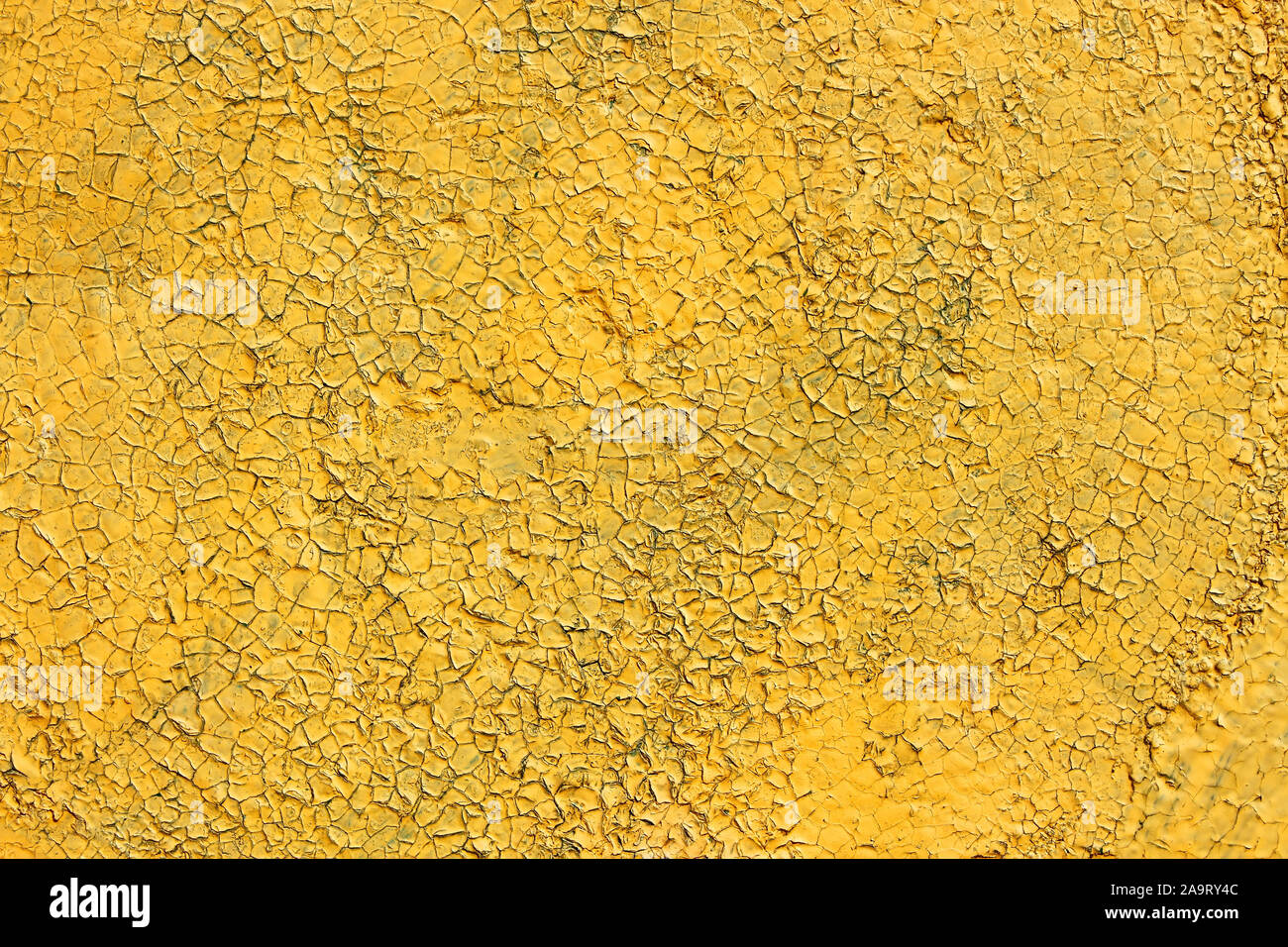 Multilayer painted shelled and cracked yellow surface outdoors as the ...