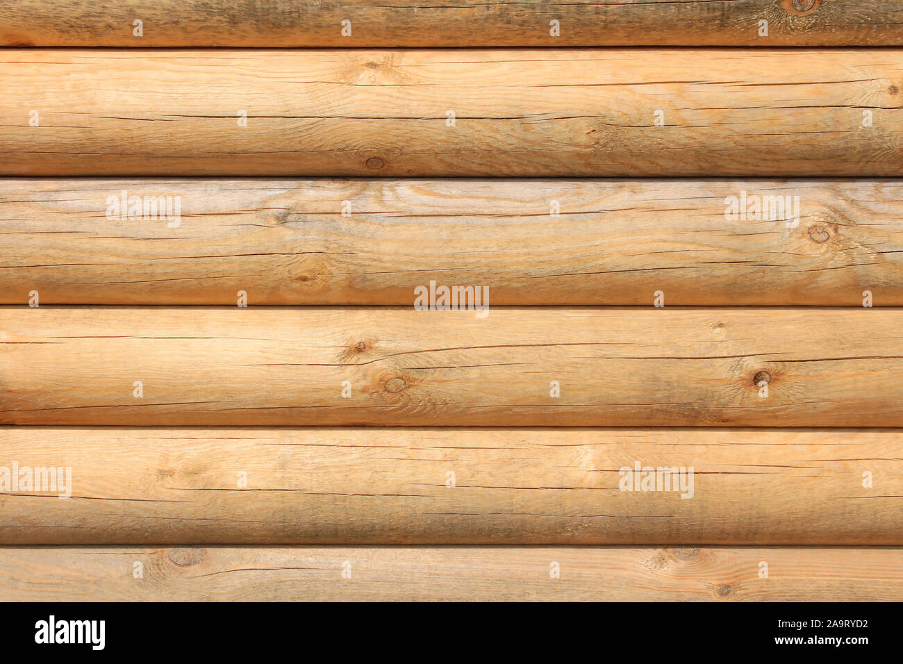 Horizontal parallel large new wooden logs in sunlight, close-up and ...