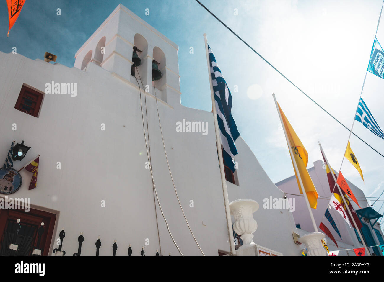 Myonos street with colorful flags, Mykonos , Greece Stock Photo - Alamy