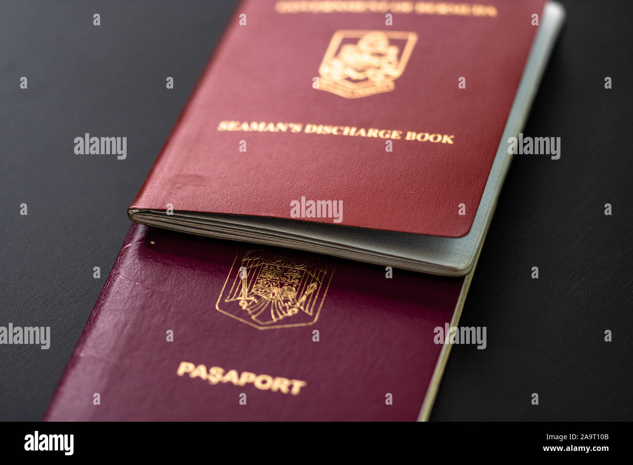 Seaman's, seafarer's discharge book and passport on black background ...