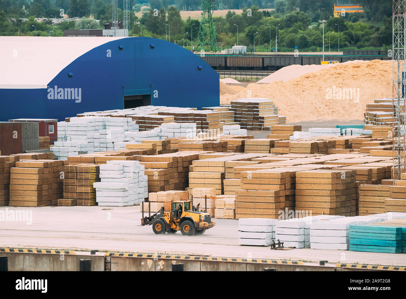 Industrial Forklift Drives Near Stacked Timber In Stock. Lift Truck ...