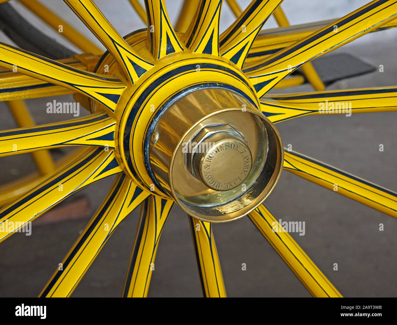 bright yellow & black spokes and axle with brass hub of wooden wheel of ...