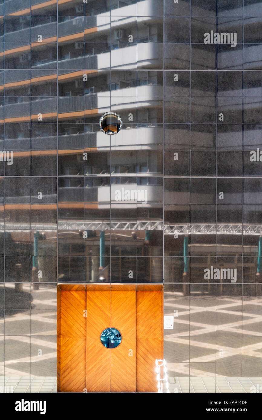 Tokyo, Asahi Beer Hall building. Wooden door entrance in black glassed ...