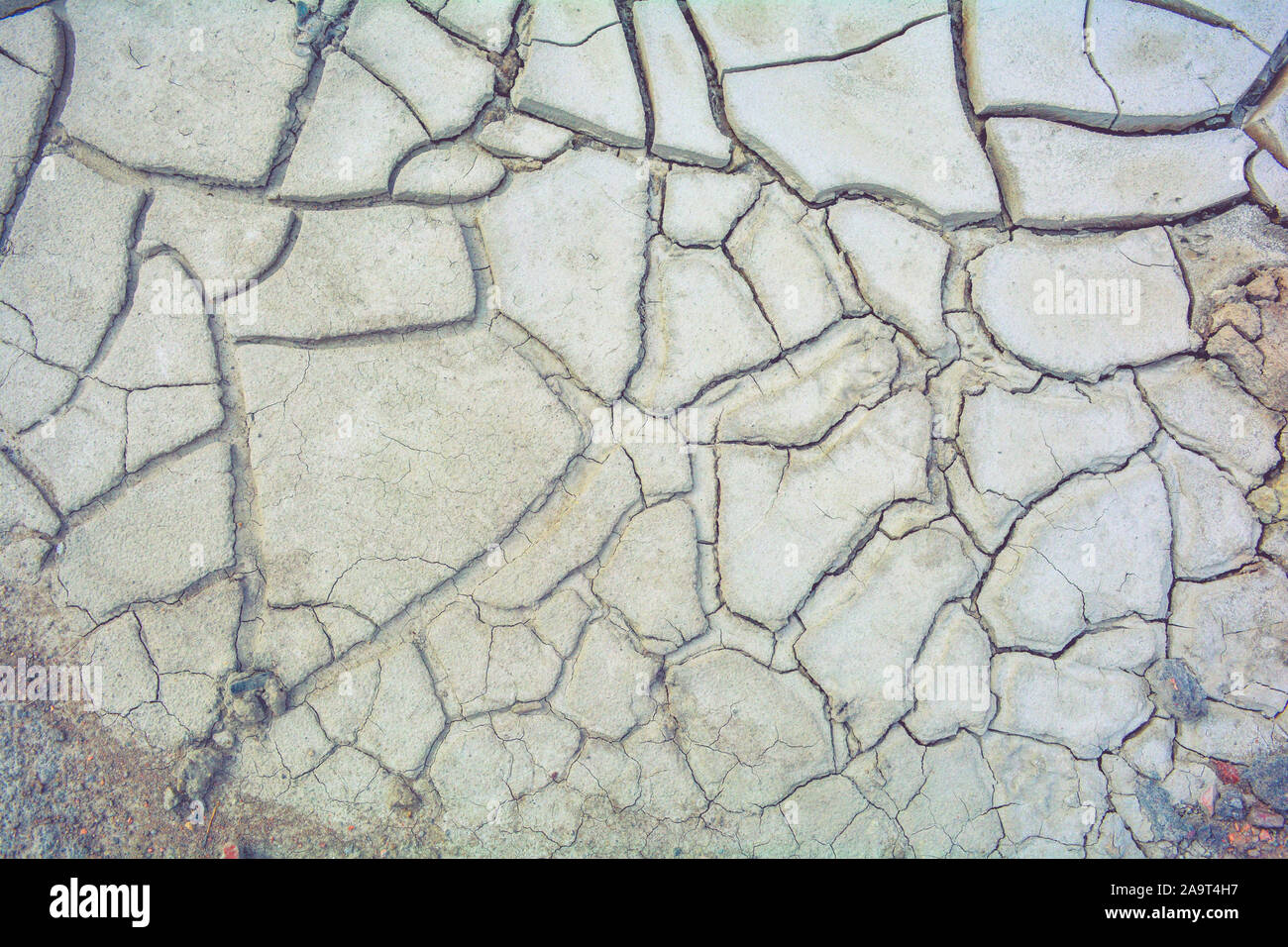 Dry mud ground with crack texture and granite gravel. Dry dirty soil on ...