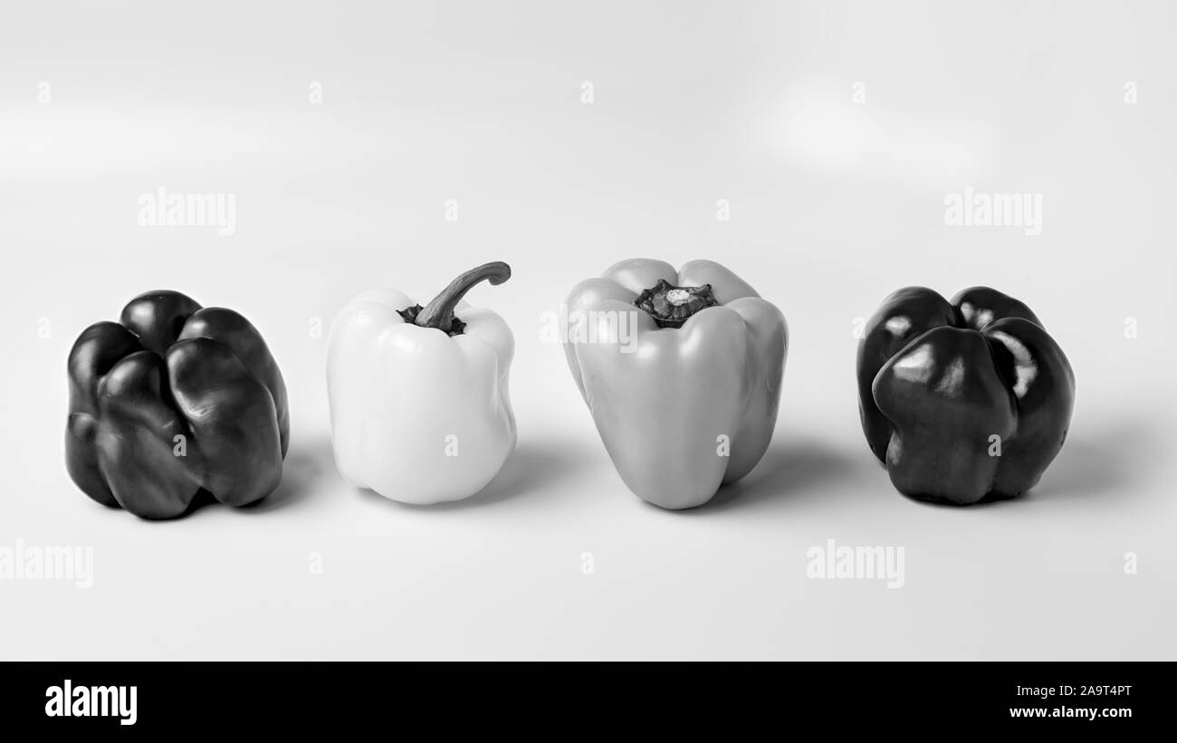 Shades of gray bell peppers all in a row Stock Photo - Alamy