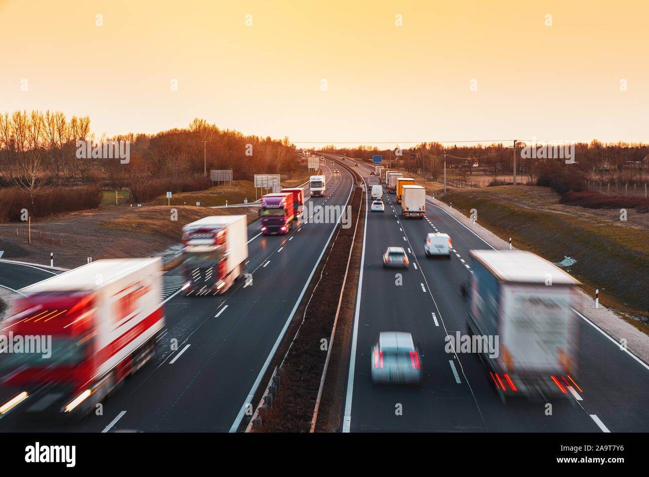 Busy highway with fast moving vehicles in beautiful sunset in Hungary ...