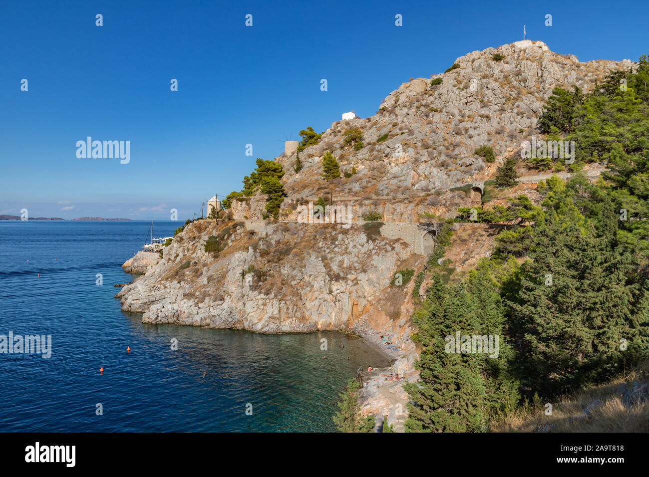 Beach with rocks and vegetation in Hydra Island, Greece Stock Photo - Alamy