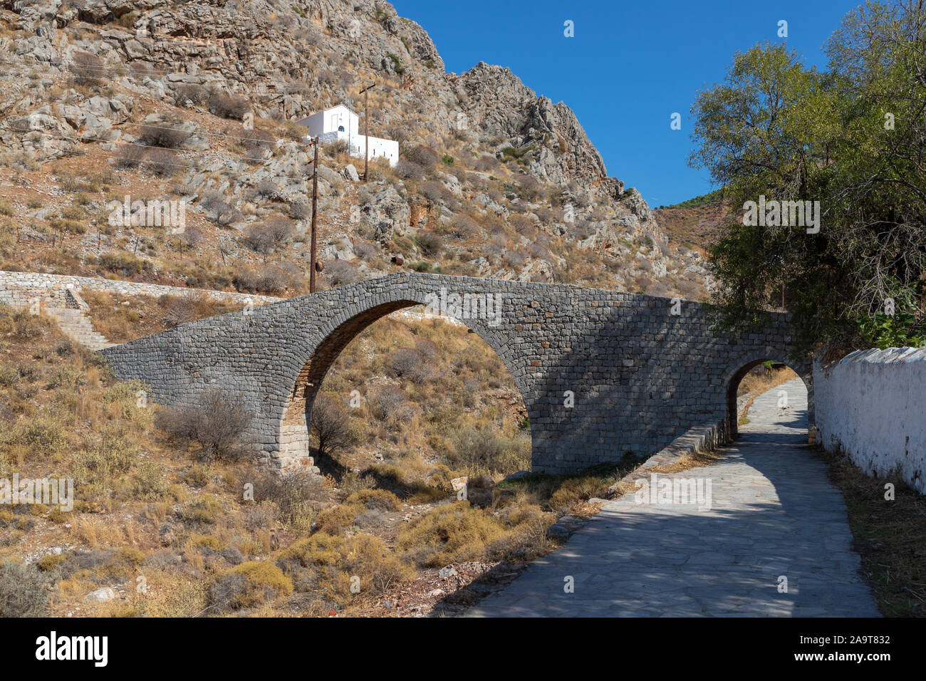 Stone bridge close to Vlychos Beach in Hydra Island, Greece Stock Photo ...