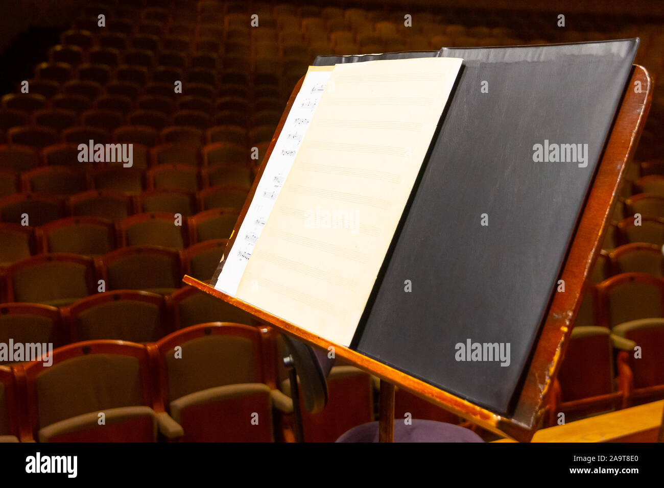 Music book and sheets with musical notation on the stand ready to the ...