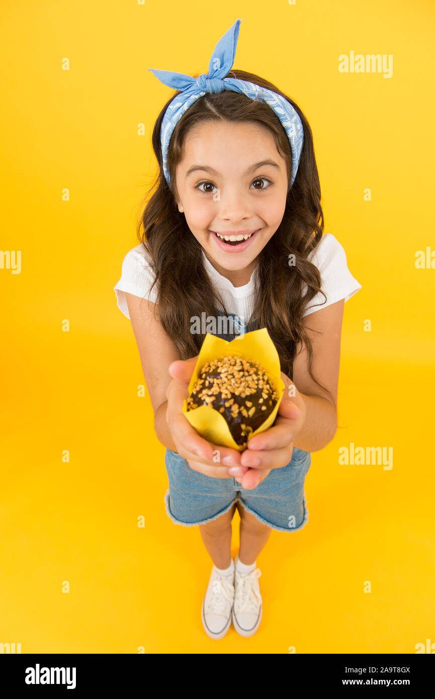 Homemade muffin. Happy childhood. Kid girl hold glazed muffins. Cafe ...