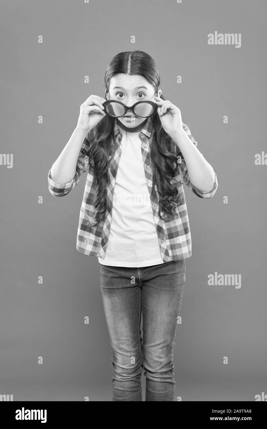 She is a smart one. Little smart girl on orange background. Adorable ...