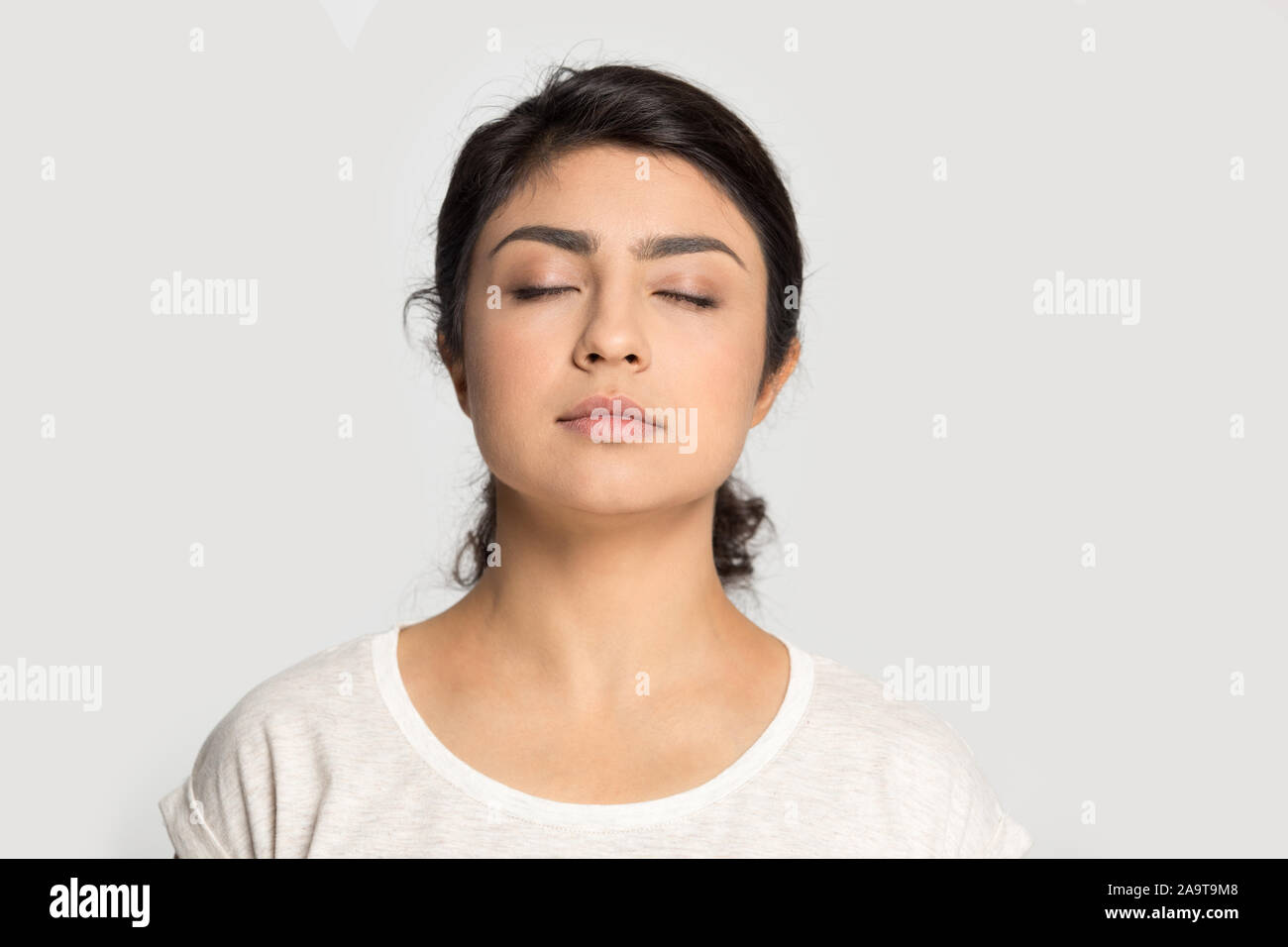 Calm Indian girl with closed eyes breathing deep, meditating Stock ...
