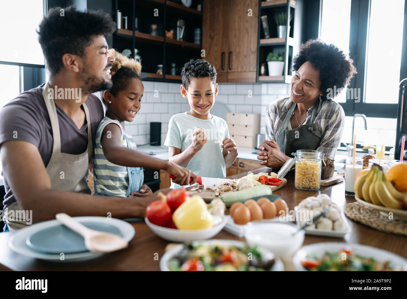 Happy family in the kitchen having fun and cooking together. Healthy ...
