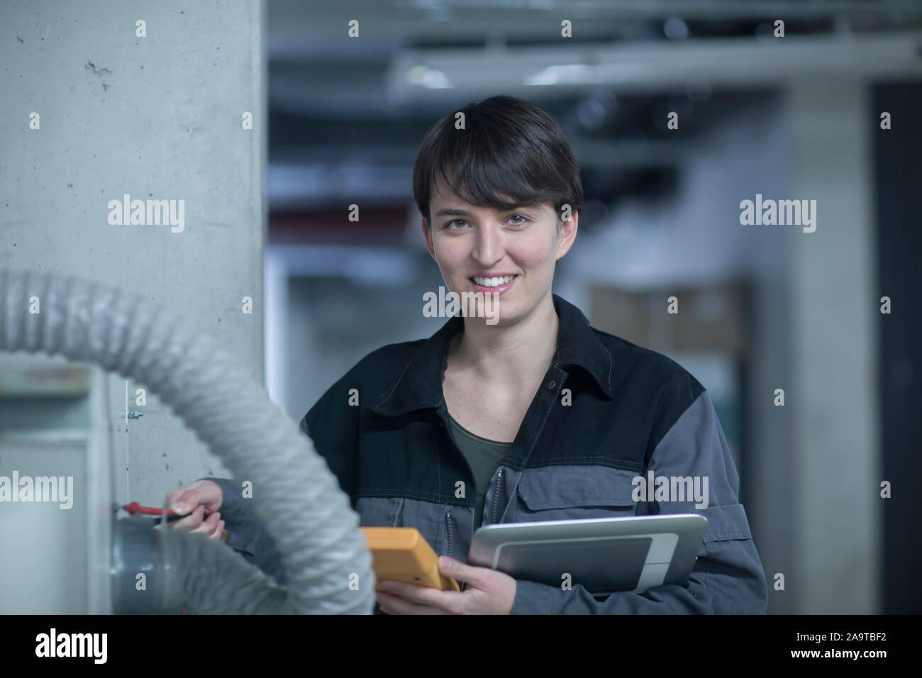 engineer woman with a device checking and controlling Stock Photo - Alamy