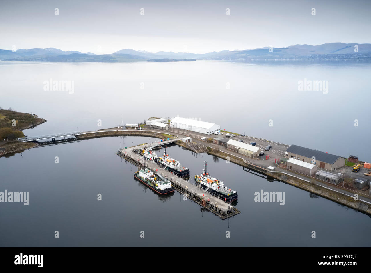 Aerial view of isolated harbour port with ferry ships and grey ...