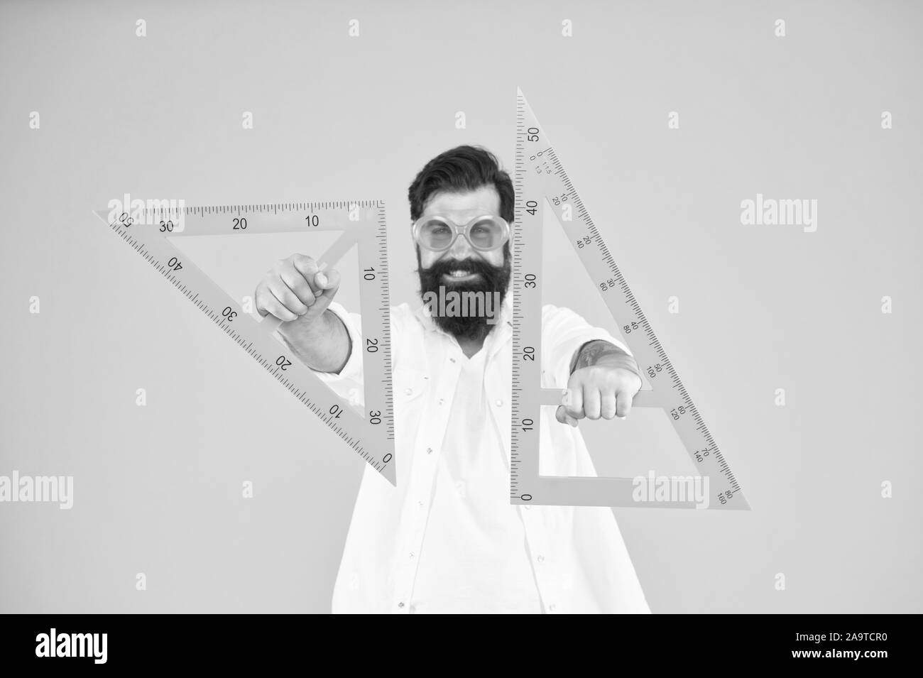 For drawing, draughting and design. Hipster holding drawing instruments ...